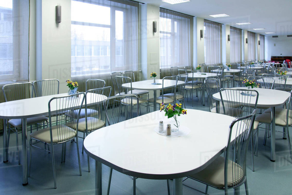 Tables and chairs in empty cafeteria - Royalty-free Stock Photo | Dissolve