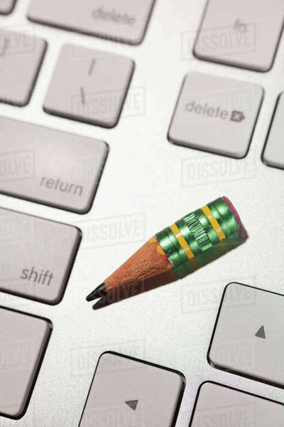 A very small sharpened lead pencil on a computer keyboard - Stock Photo ...