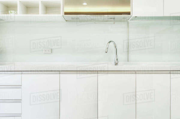 Silver arched mixer tap and sink in white modern kitchen - Royalty-free ...