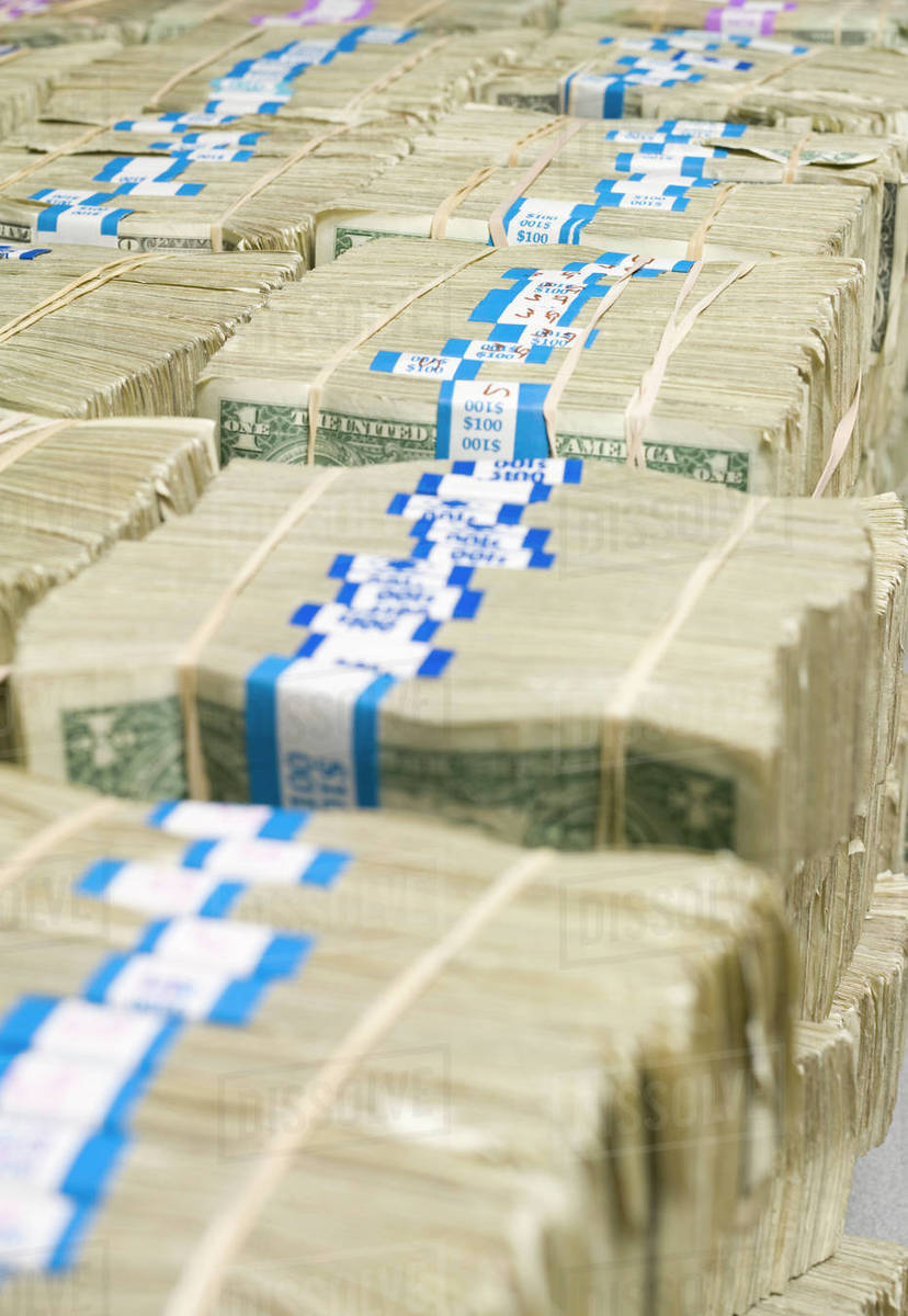 US Dollar Bills in Bundles - Stock Photo - Dissolve