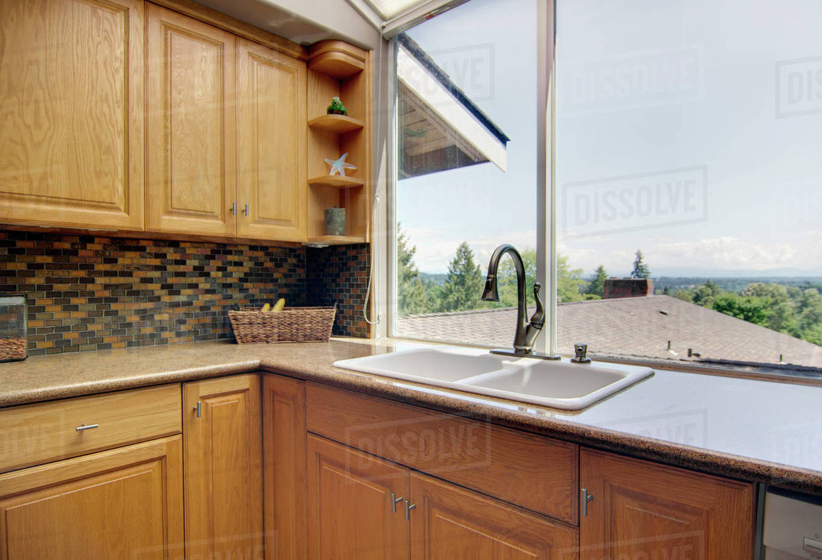 View out of the large window by the sink - Stock Photo - Dissolve