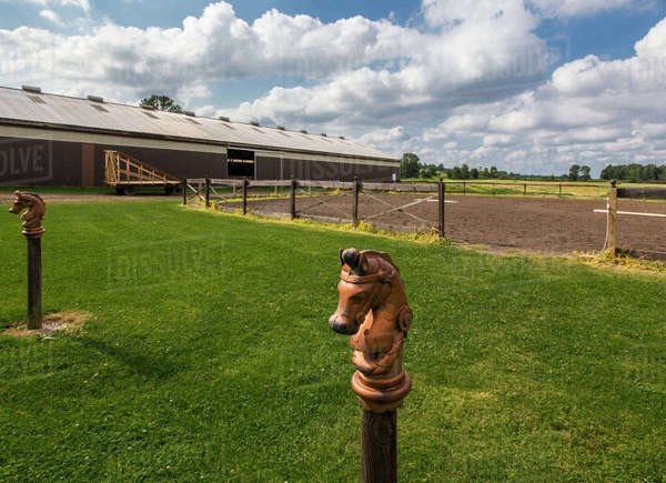 Decorative horse posts on farm - Royalty-free Stock Photo | Dissolve
