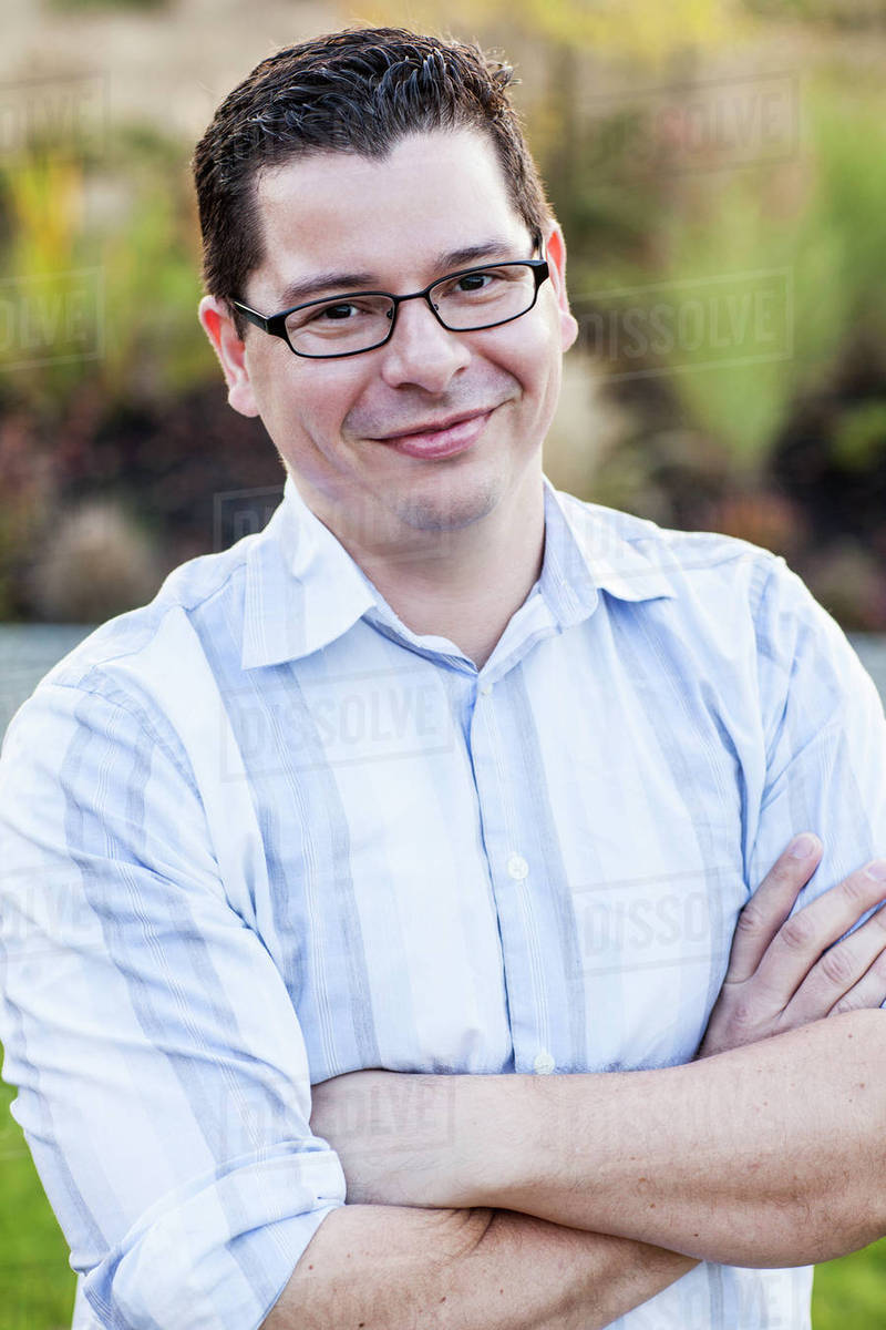Hispanic man smiling outdoors - Royalty-free Stock Photo | Dissolve