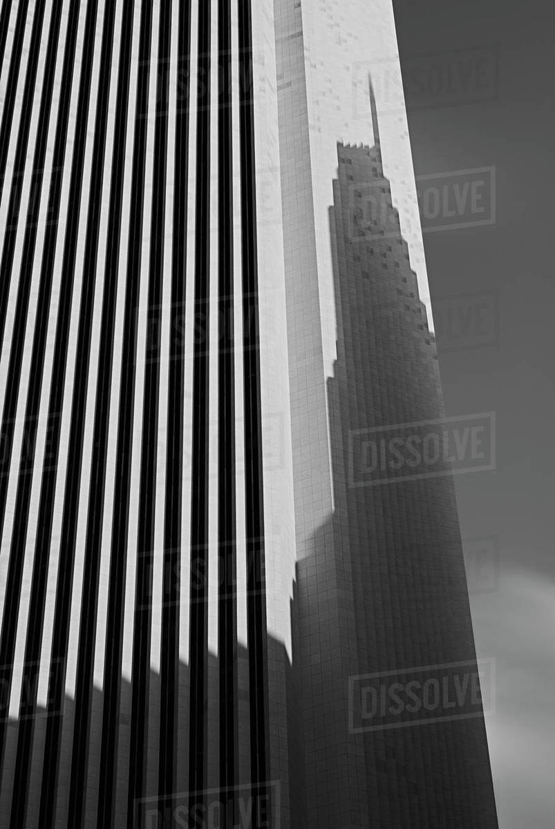 Skyscraper casting shadow on office building - Royalty-free Stock Photo ...