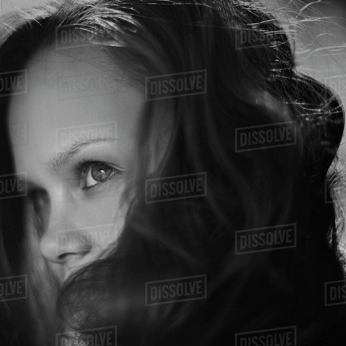 Caucasian girl peering over her hair - Royalty-free Stock Photo | Dissolve