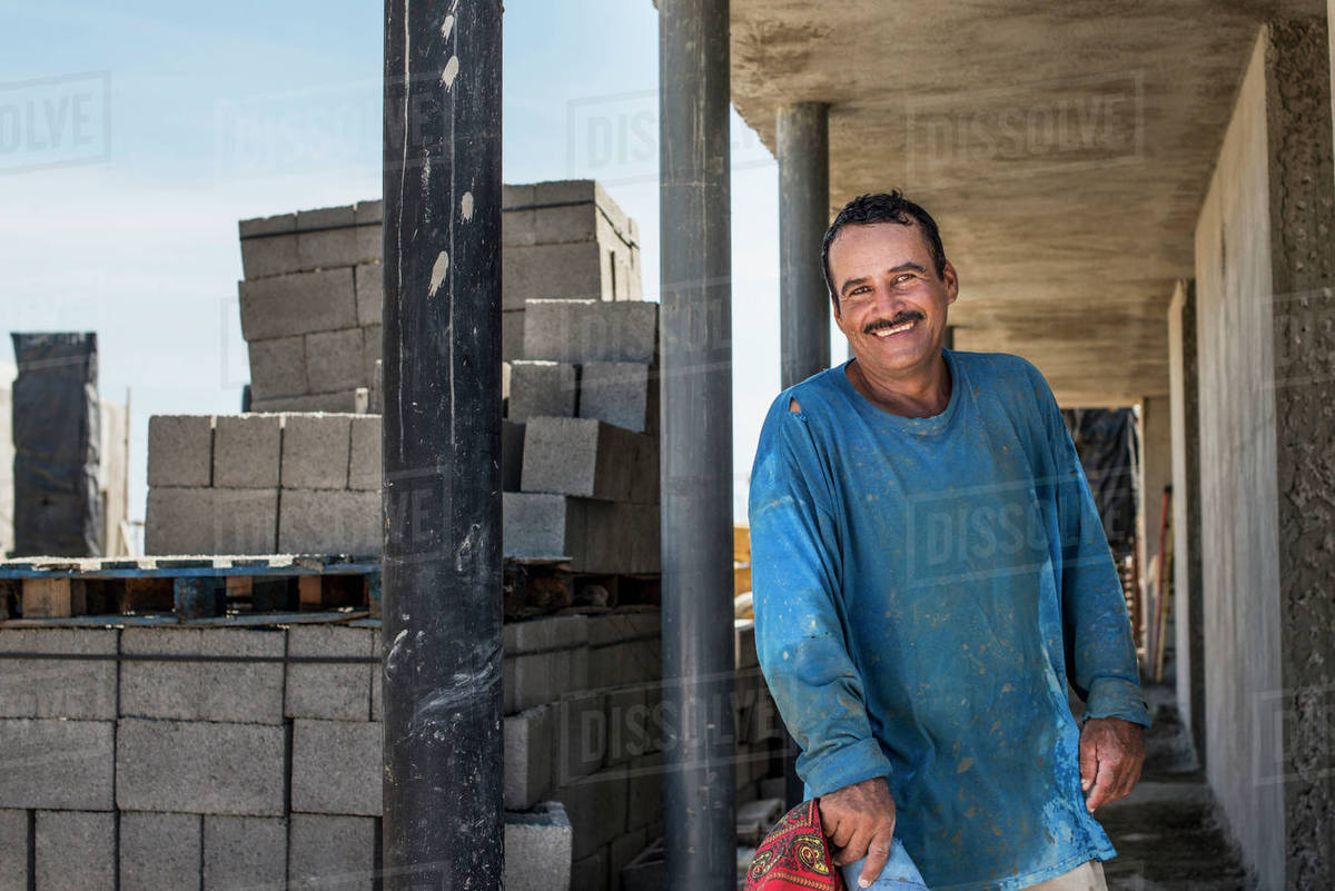 Hispanic construction worker smiling at construction site - Stock Photo ...