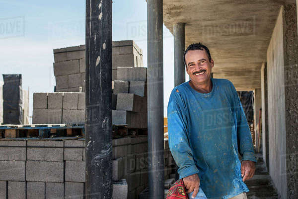 Hispanic construction worker smiling at construction site - Stock Photo ...