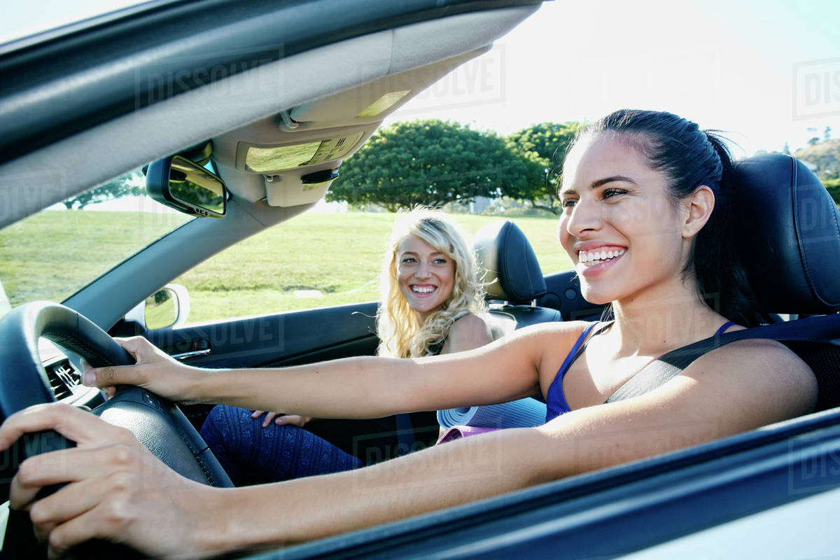 Excited women driving convertible on road trip - Royalty-free Stock ...
