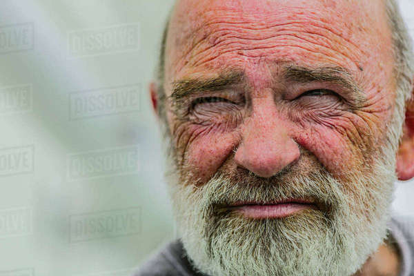 Close up of wrinkled face of Caucasian man - Stock Photo - Dissolve