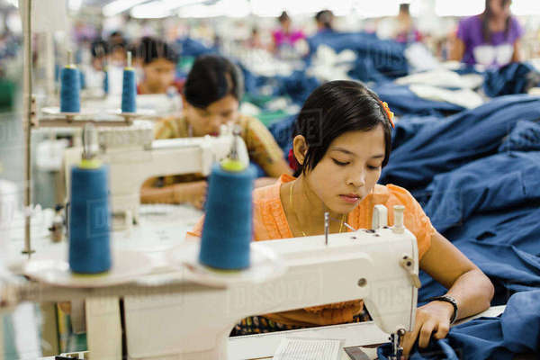Asian worker sewing clothing in garment factory - Royalty-free Stock ...