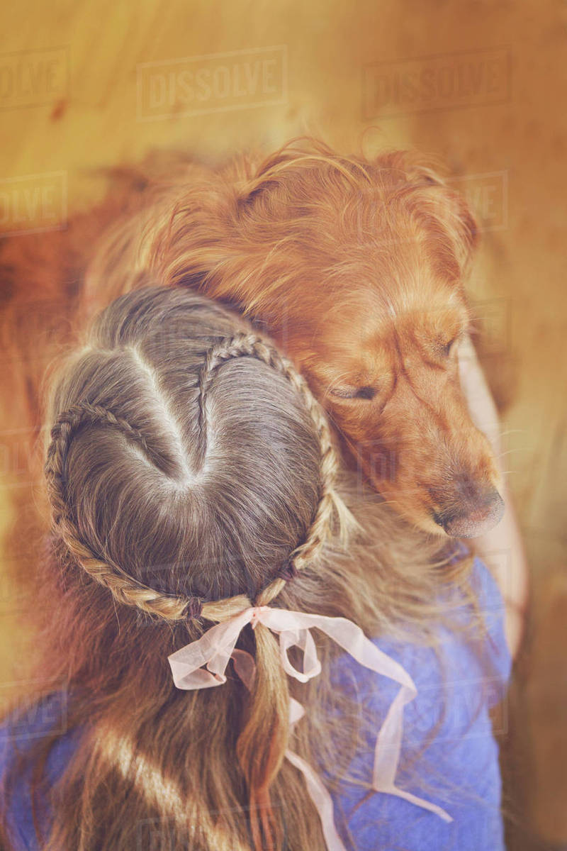 Caucasian girl hugging dog - Stock Photo - Dissolve