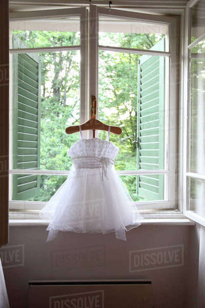 Formal dress hanging in window - Stock Photo - Dissolve