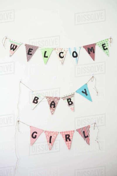 Welcome Baby Girl sign on wall - Stock Photo - Dissolve