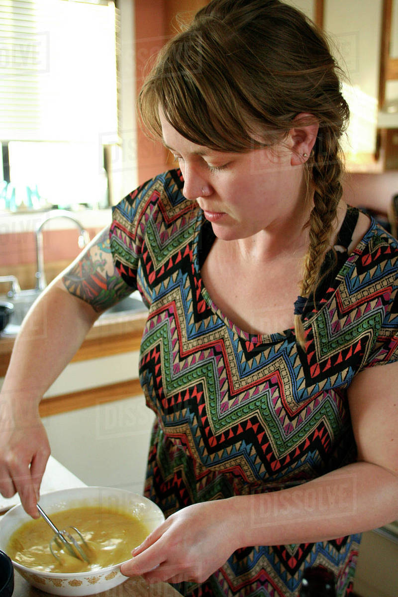 Close up of woman cooking in kitchen - Stock Photo - Dissolve