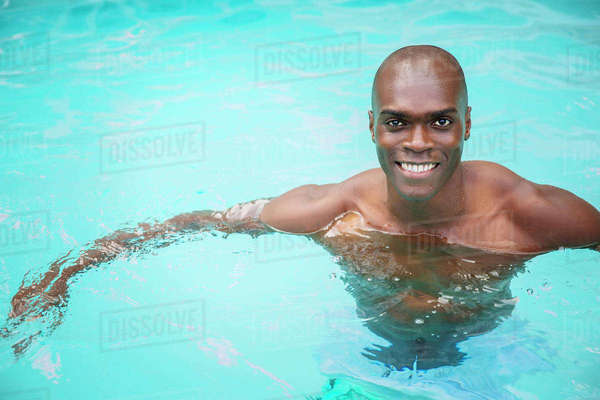 Black man swimming in pool - Royalty-free Stock Photo | Dissolve