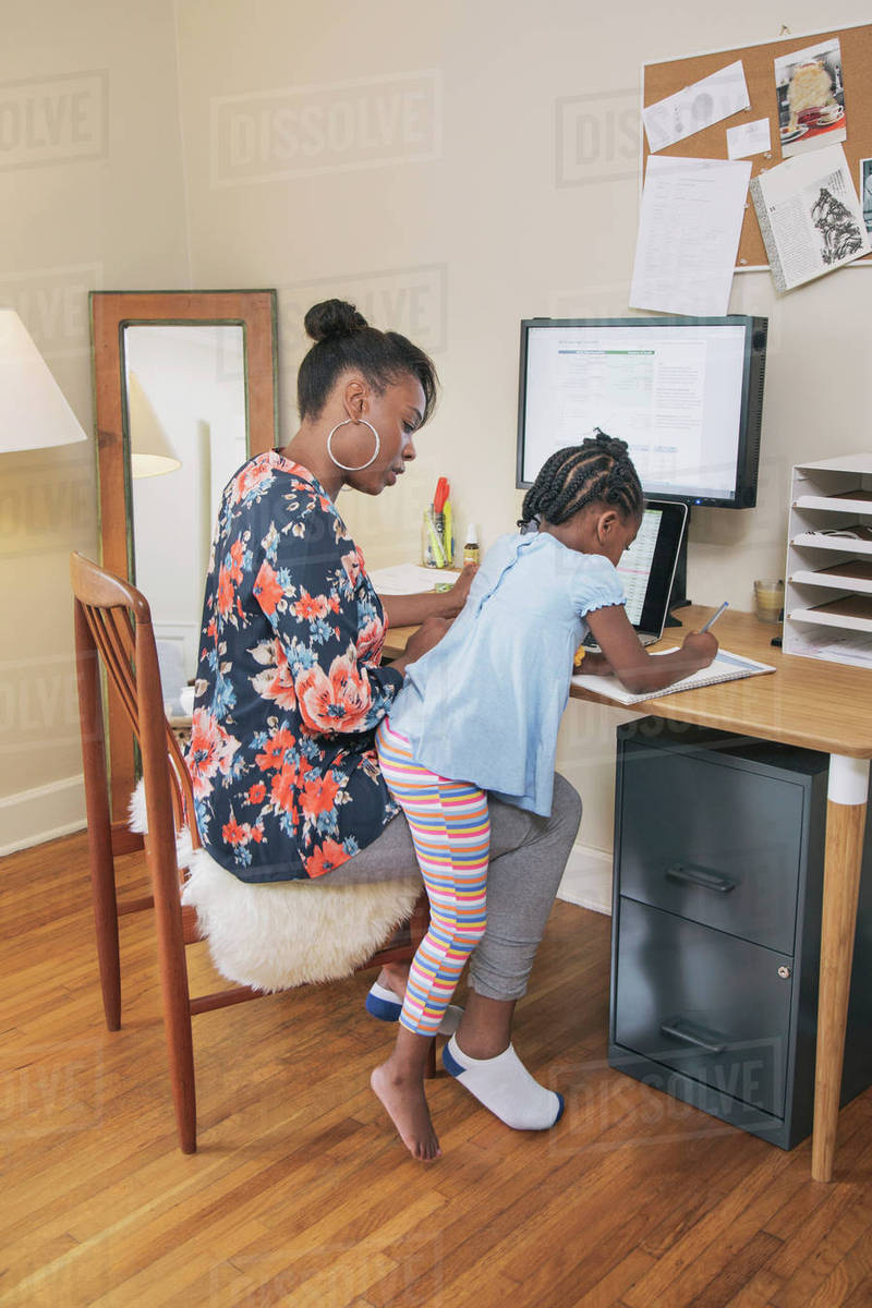 African American mother with daughter working from home - Royalty-free ...