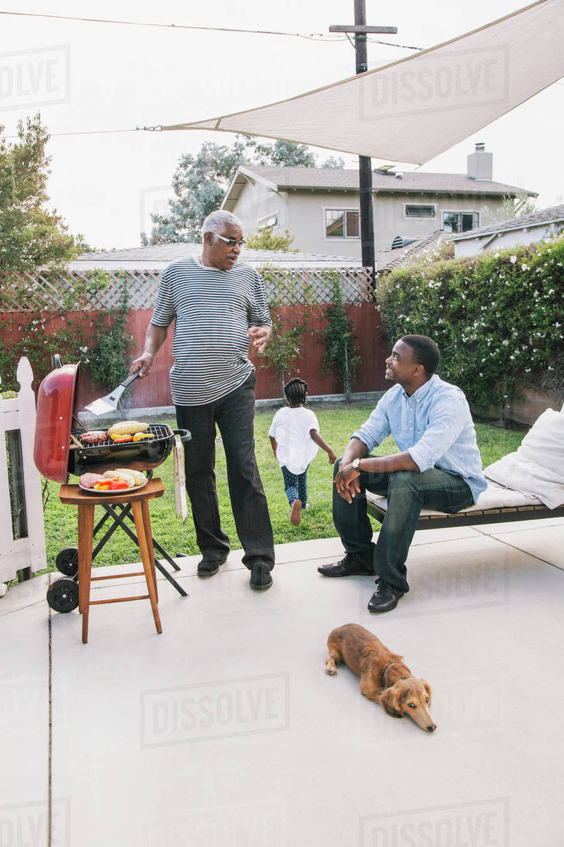 African American father and son talking at barbecue - Stock Photo ...