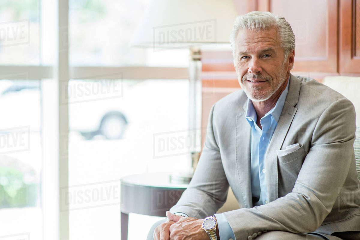 Caucasian man sitting near window - Stock Photo - Dissolve