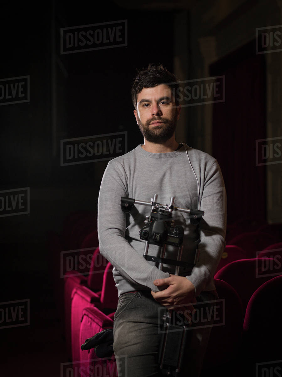 Caucasian man holding projector in movie theater - Royalty-free Stock ...