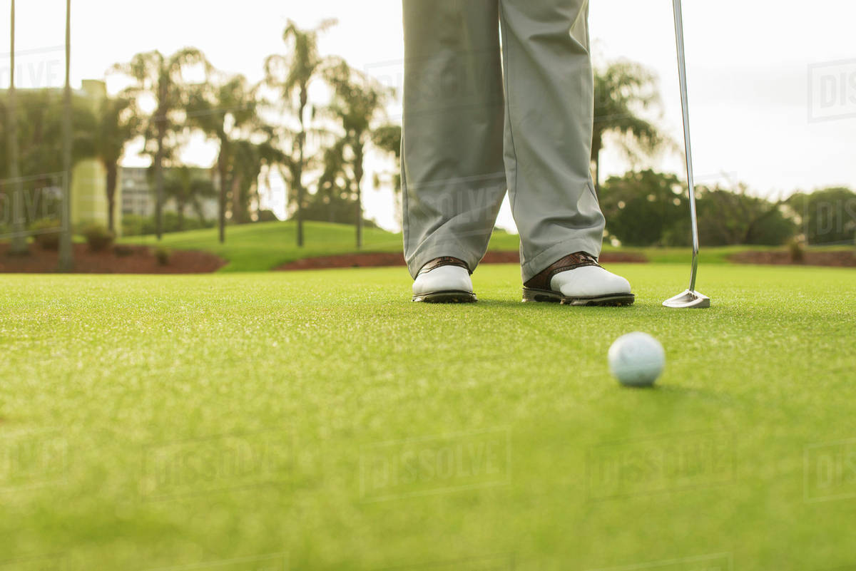 Caucasian man standing on golf course green - Royalty-free Stock Photo ...