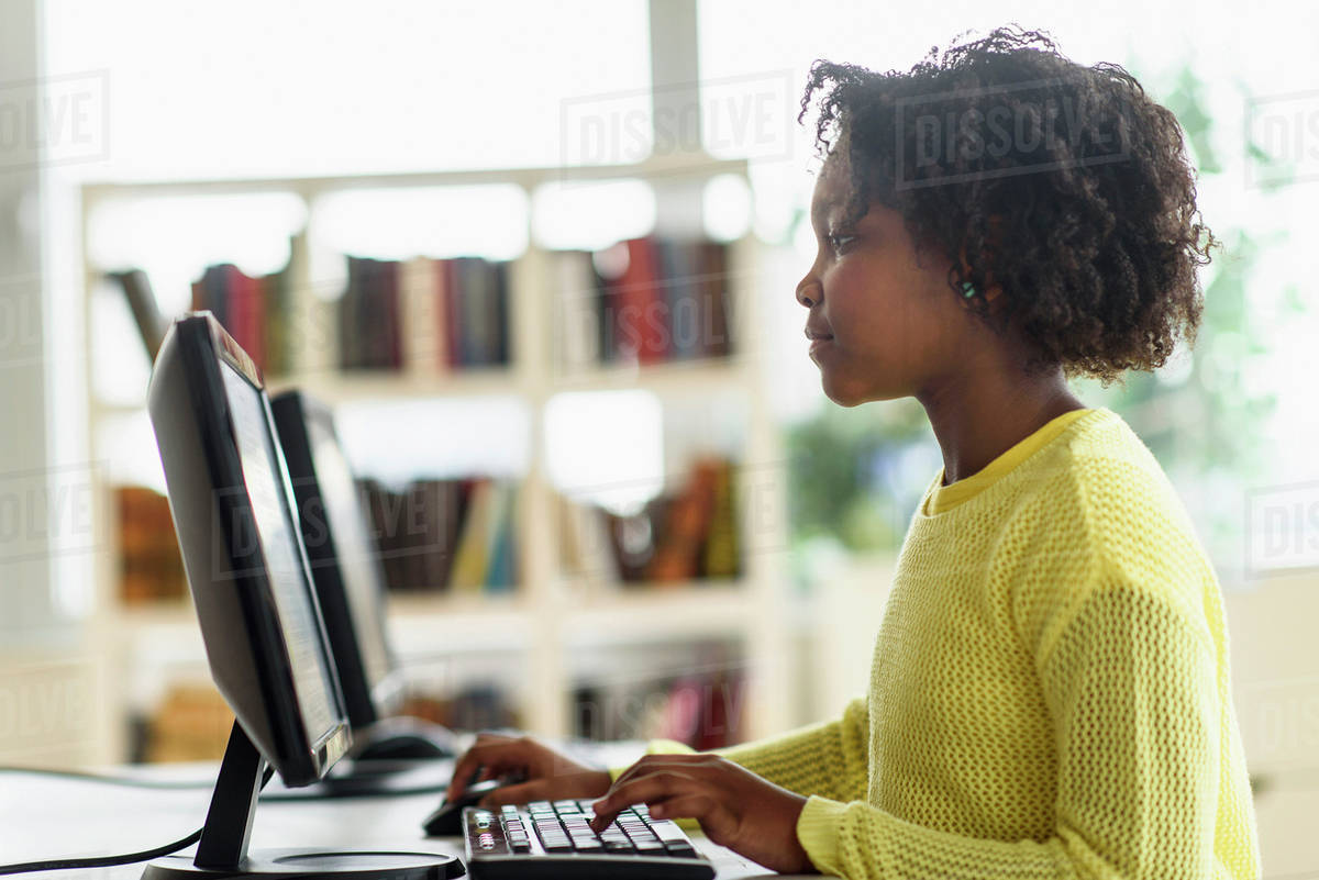 Black student using computer in classroom - Stock Photo - Dissolve