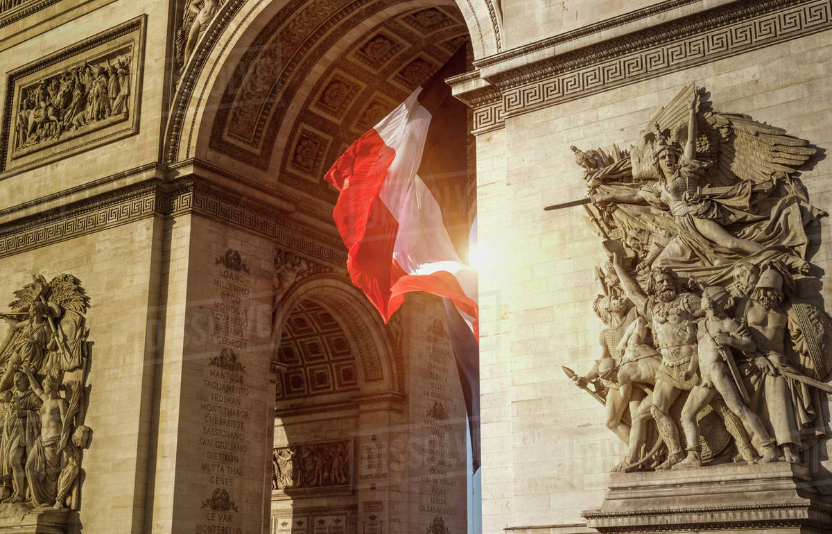 Flag in arch near statues - Royalty-free Stock Photo | Dissolve