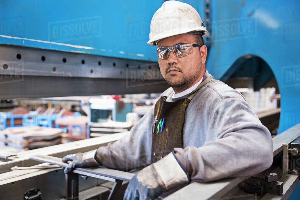 Pacific Islander worker posing in factory - Royalty-free Stock Photo ...