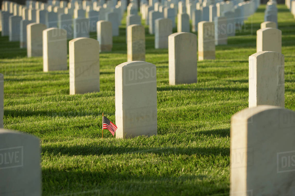 American flag at cemetery gravestone - Royalty-free Stock Photo | Dissolve