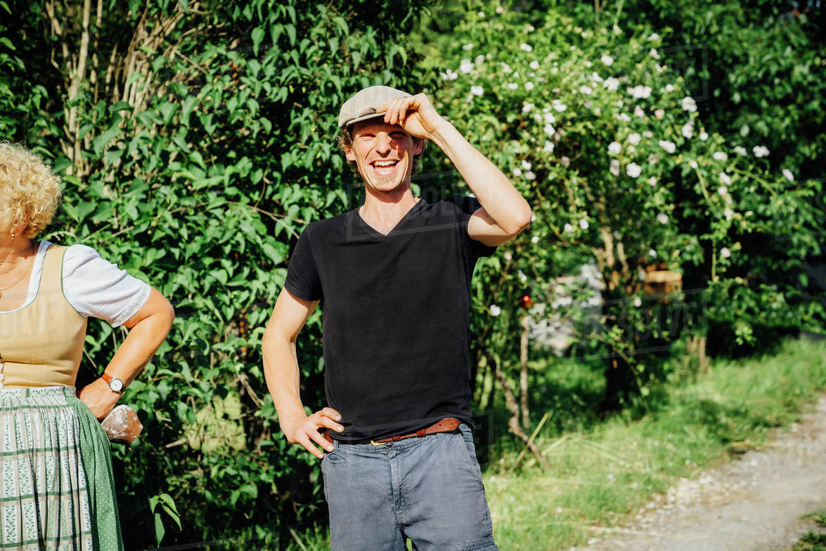 Smiling Caucasian man tipping cap - Stock Photo - Dissolve