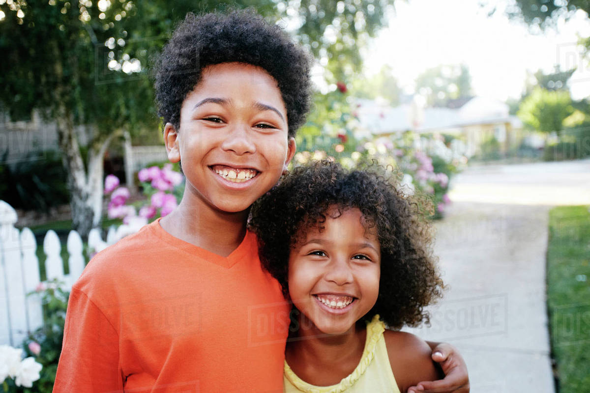 Smiling Mixed Race brother and sister hugging outdoors - Royalty-free ...
