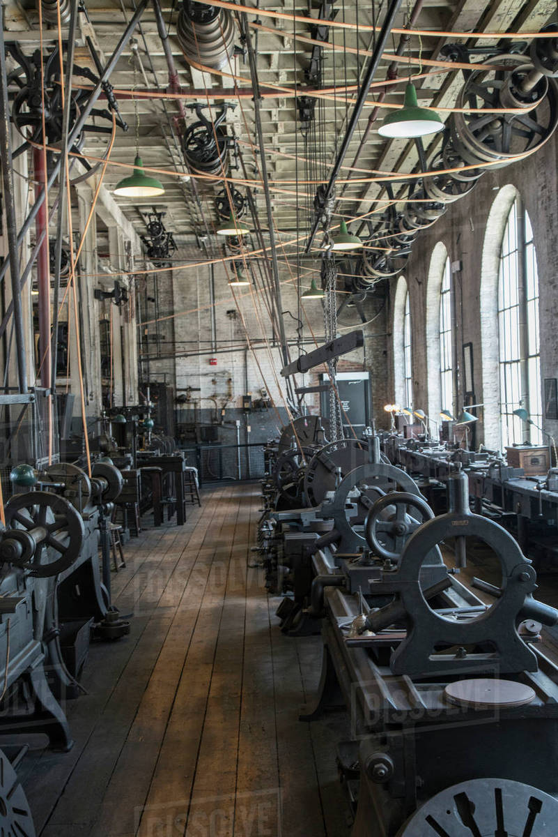 Pulleys and machinery in empty old-fashioned factory - Royalty-free ...