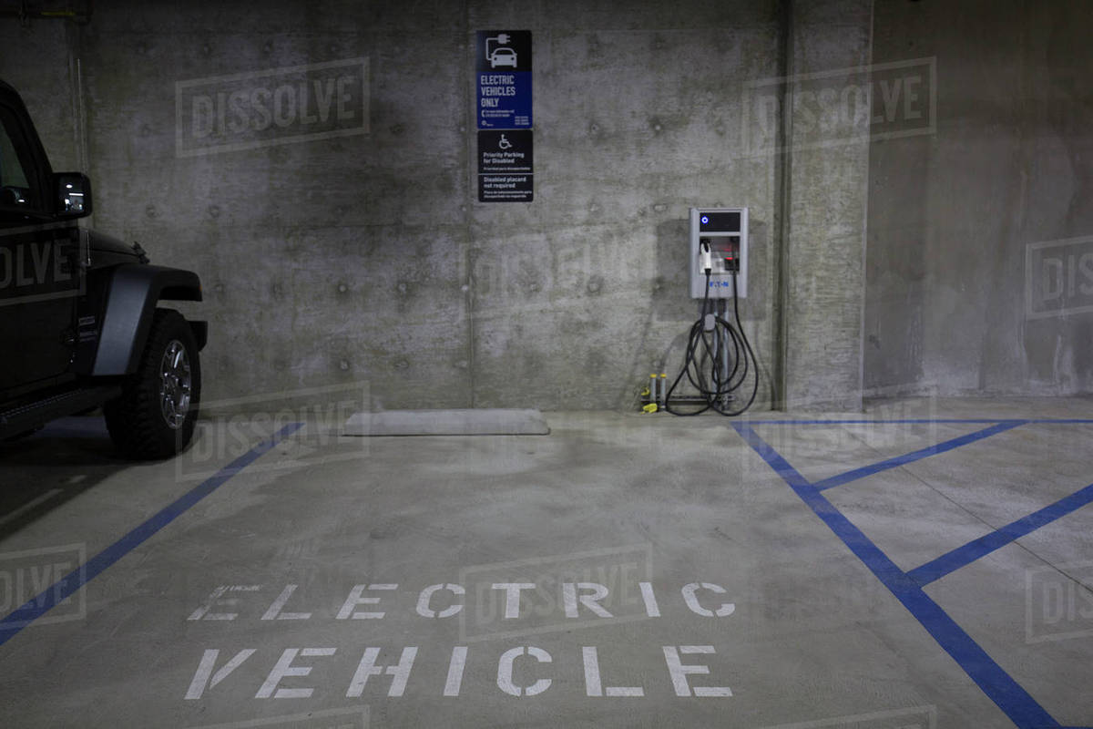 Electric vehicle parking space and charging station - Royalty-free ...