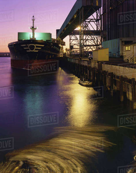 Cargo ship in harbor at night - Stock Photo - Dissolve