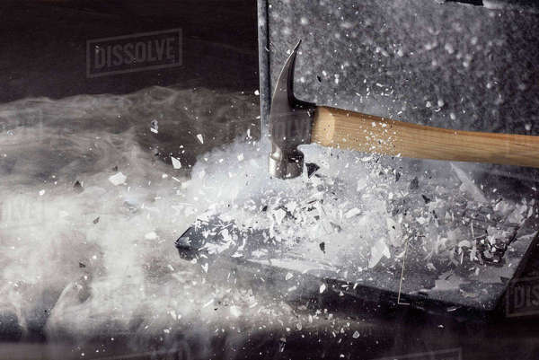Hammer breaking ice on frozen laptop - Royalty-free Stock Photo | Dissolve