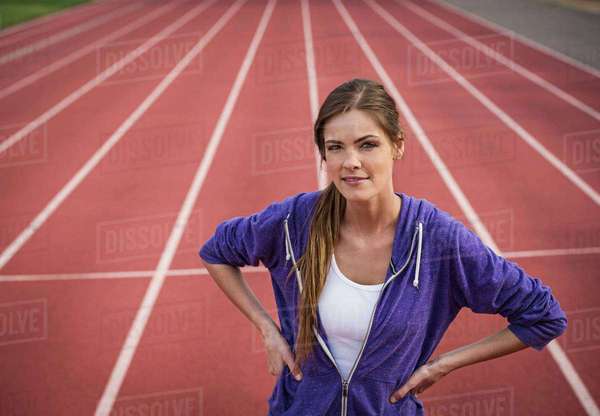 Caucasian woman posing on running track - Royalty-free Stock Photo ...