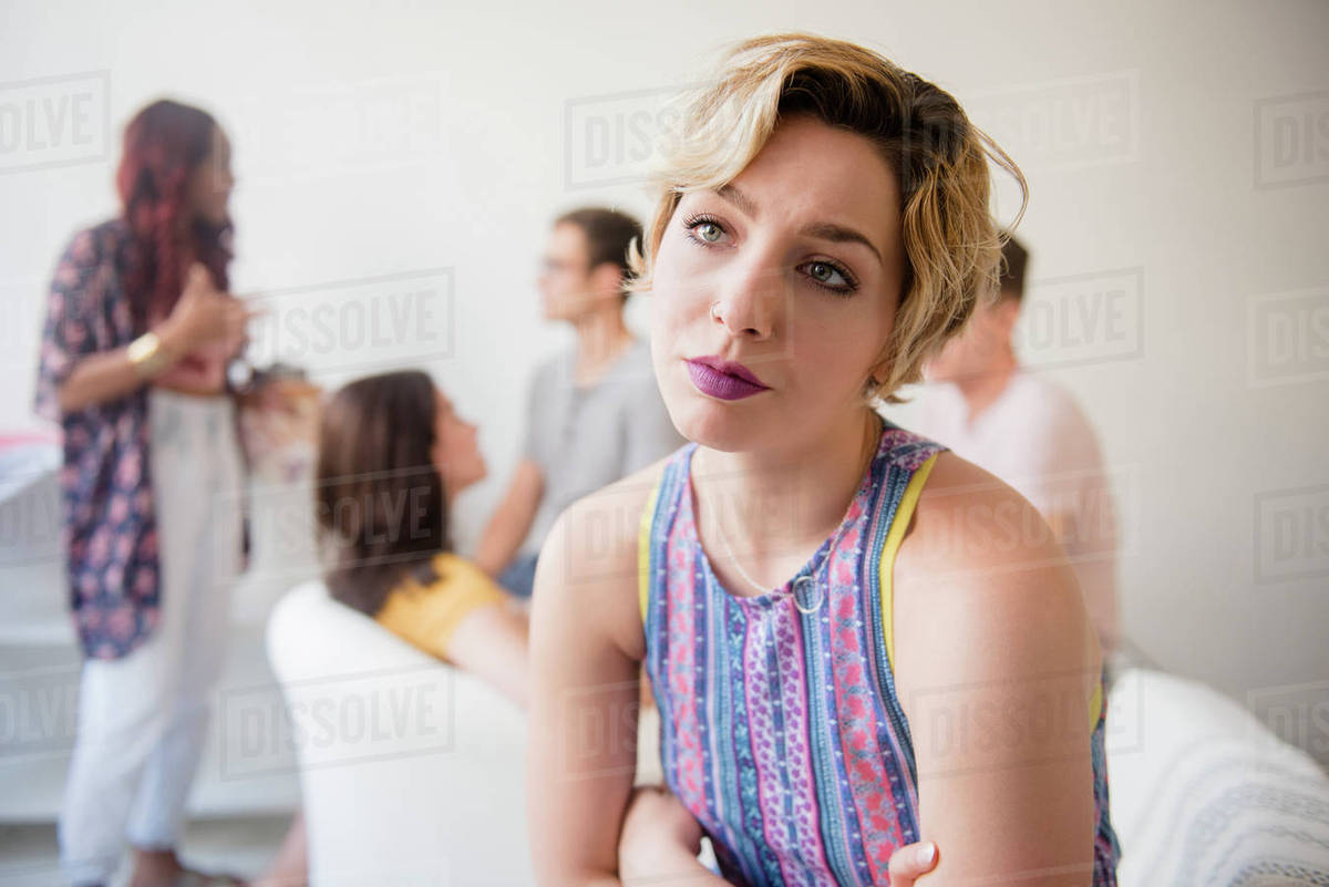 Portrait of woman sulking at party - Royalty-free Stock Photo | Dissolve