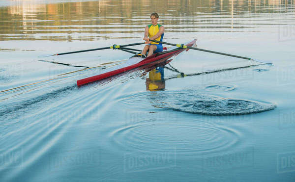 Caucasian man rowing on lake - Stock Photo - Dissolve