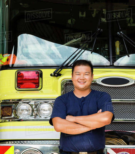 Smiling Chinese fireman posing with fire truck - Royalty-free Stock ...