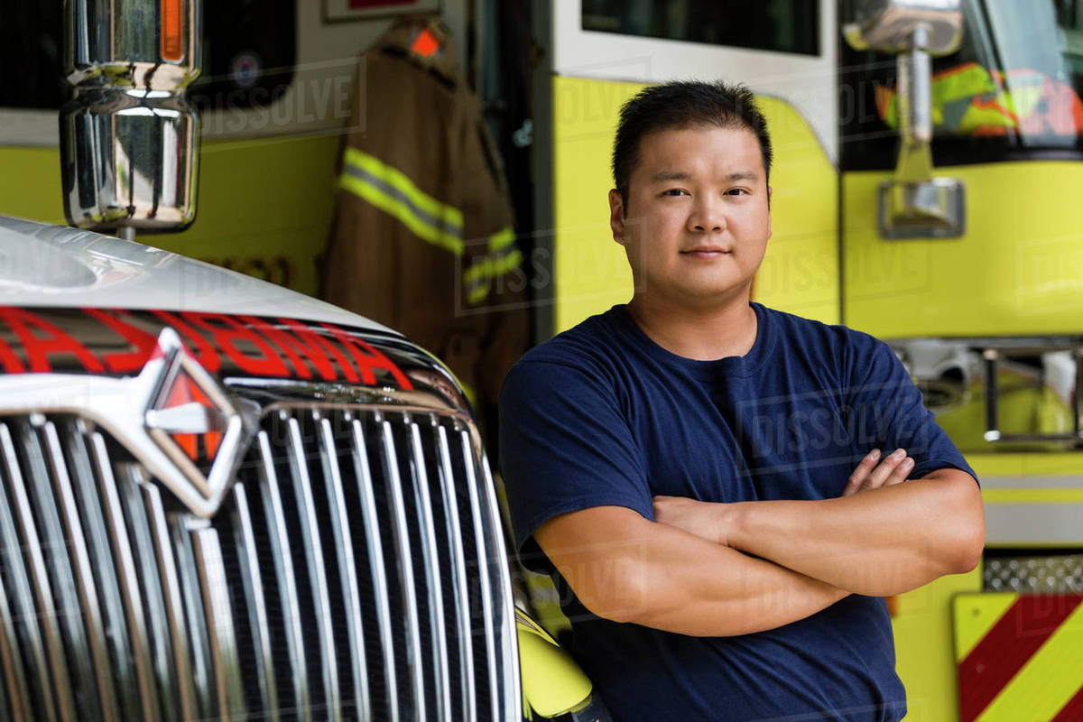 Serious Chinese fireman posing with fire truck - Royalty-free Stock ...