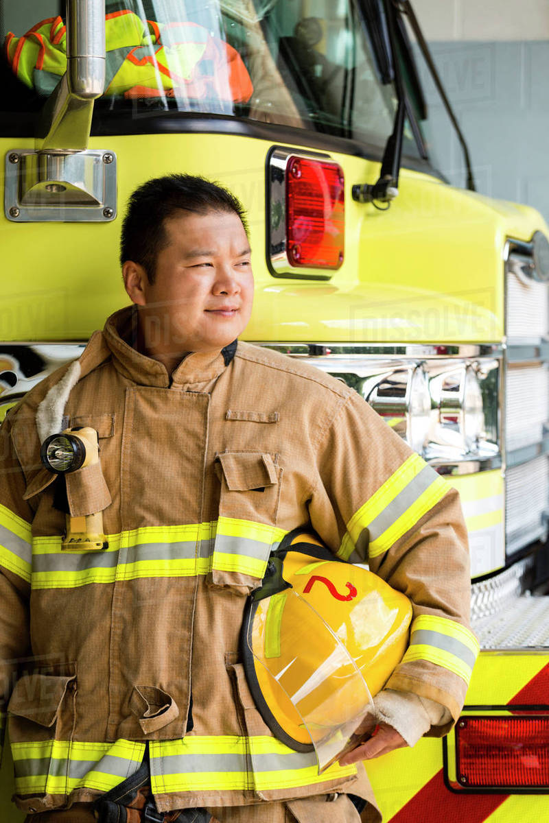 Chinese fireman standing near fire trucks - Royalty-free Stock Photo ...