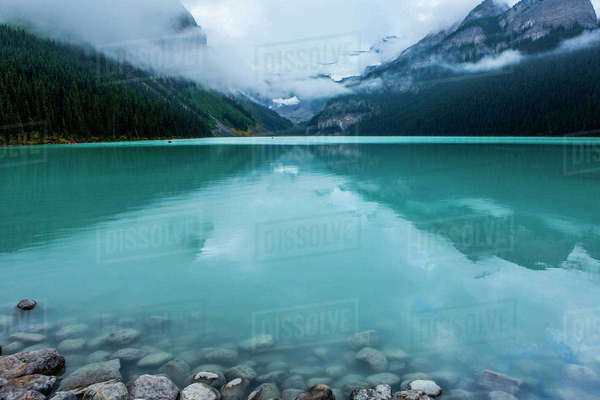 Reflection of clouds in still mountain lake - Royalty-free Stock Photo ...