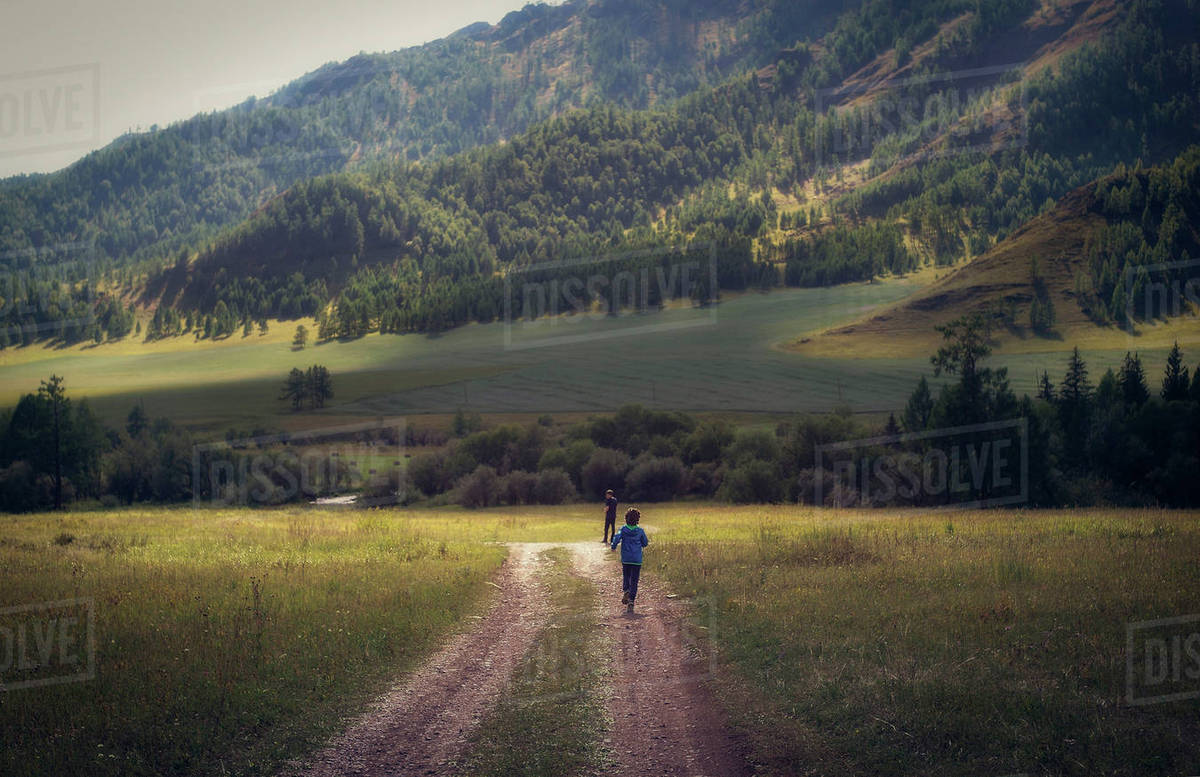 Caucasian boys walking on remote path - Royalty-free Stock Photo | Dissolve