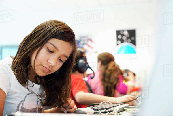 Hispanic student working at desk in classroom - Royalty-free Stock ...