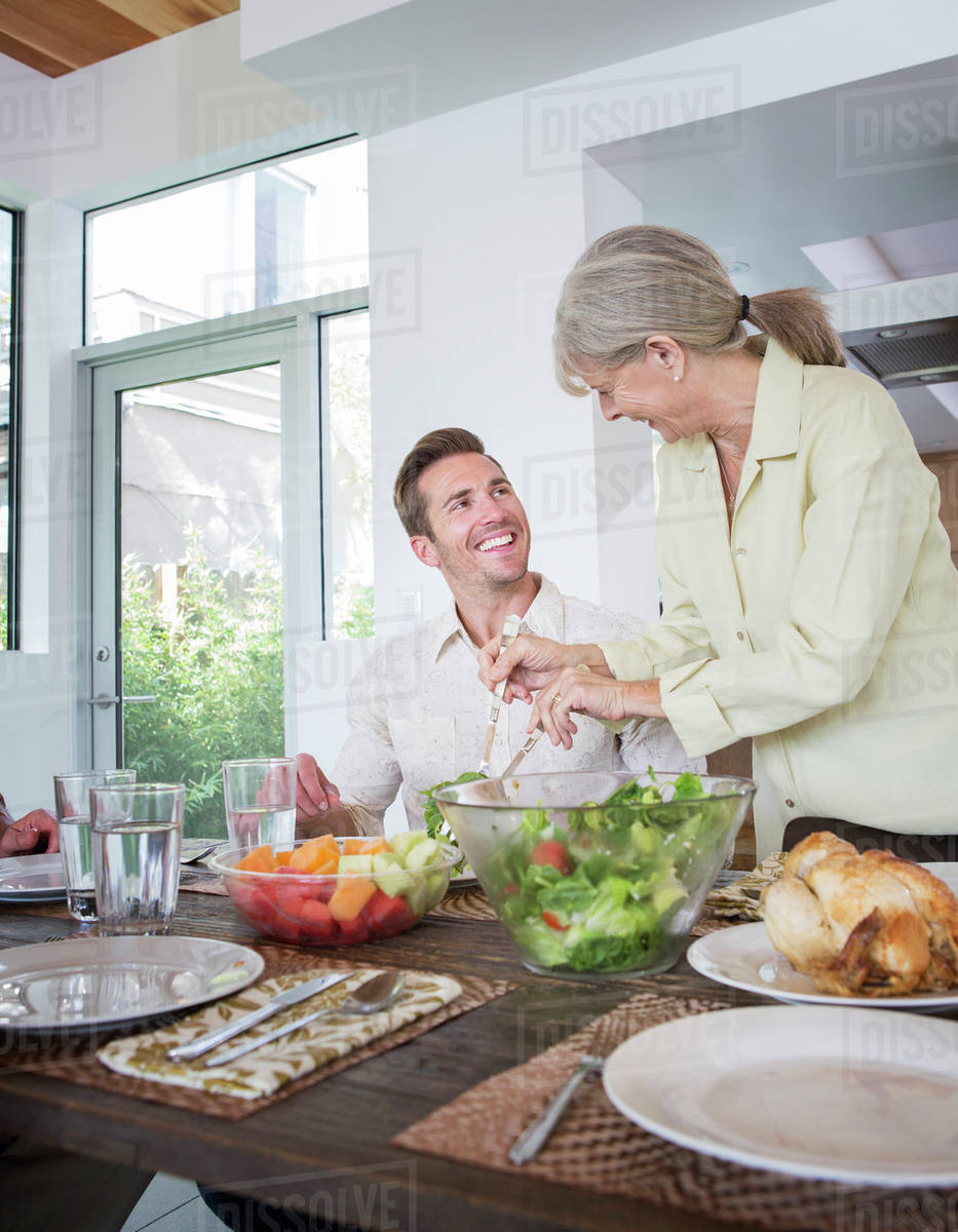 Caucasian mother serving son at table - Stock Photo - Dissolve