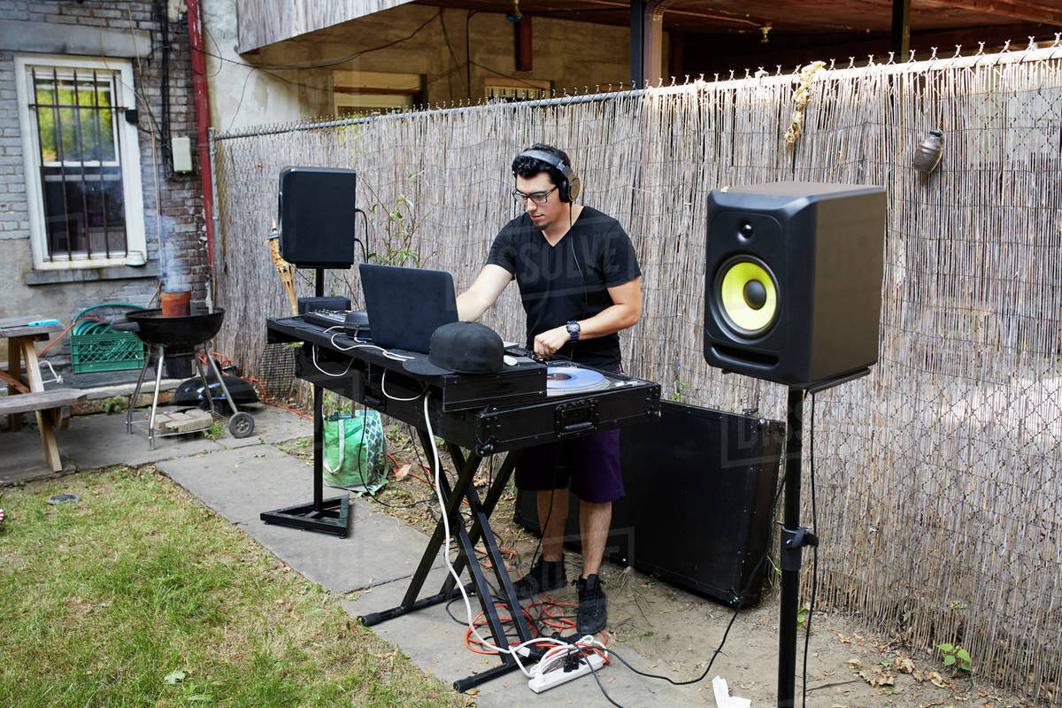 Dj playing music in backyard - Royalty-free Stock Photo | Dissolve