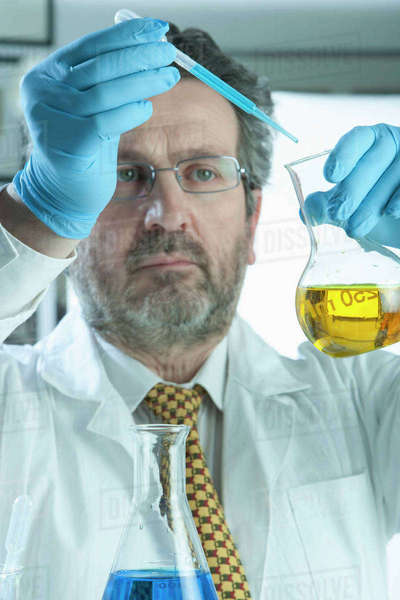 Scientist mixing liquid in laboratory - Royalty-free Stock Photo | Dissolve