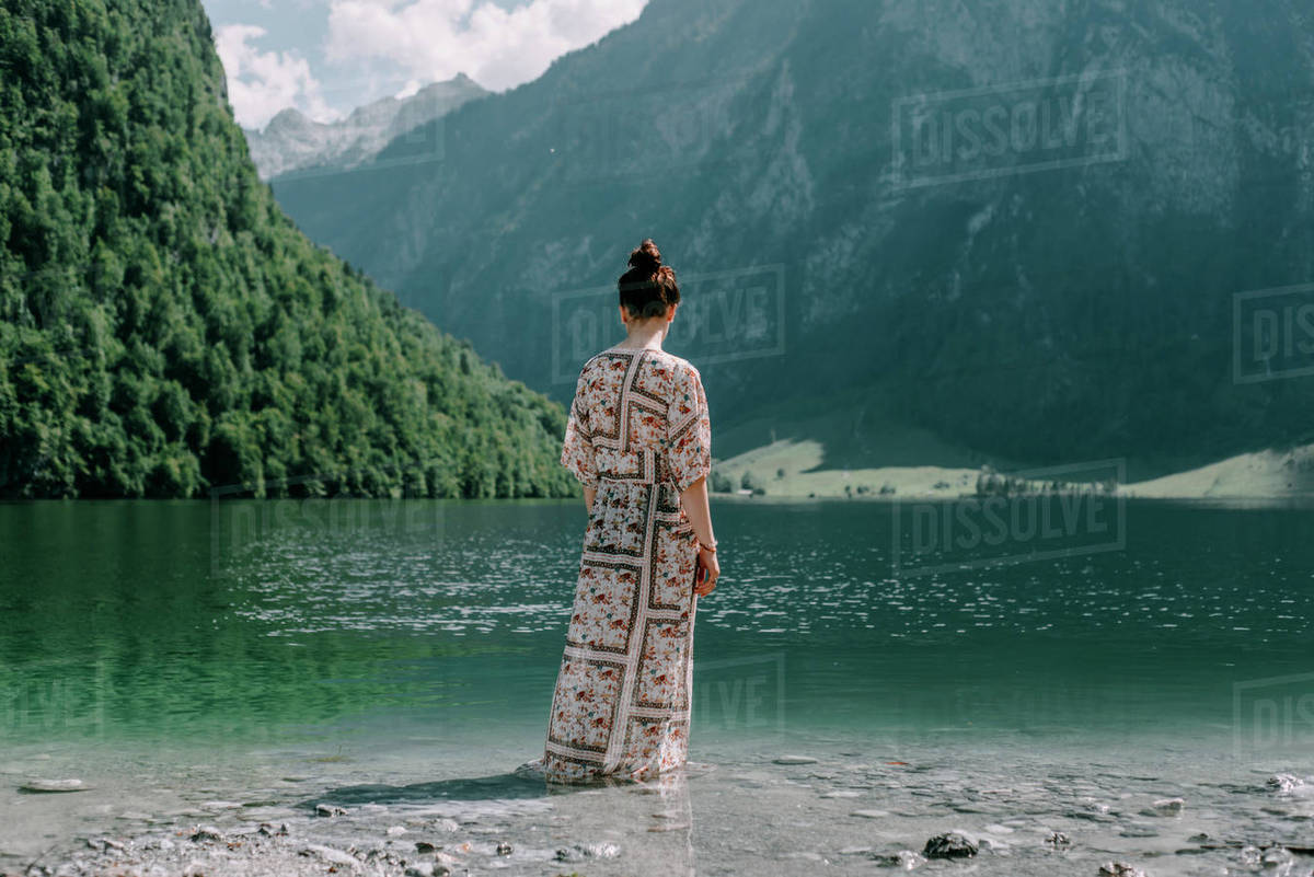 Caucasian woman wading in mountain lake - Royalty-free Stock Photo ...