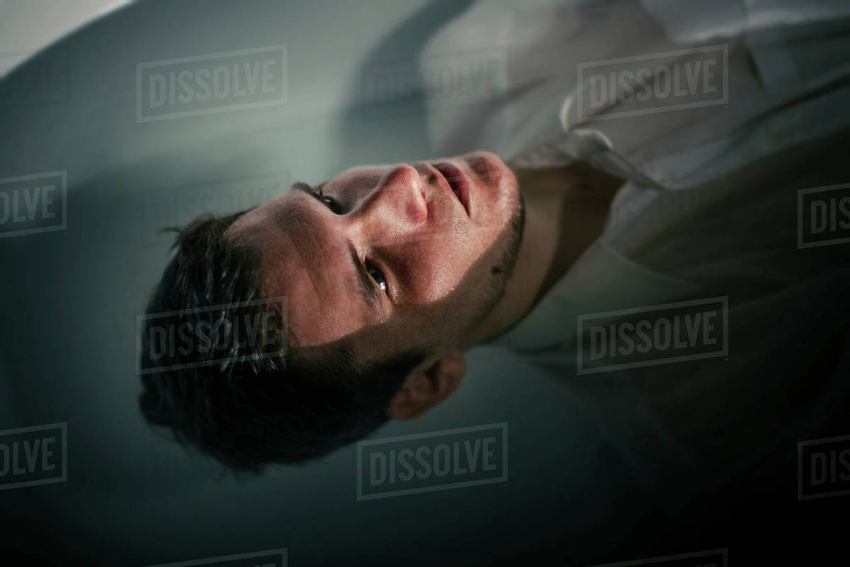 Caucasian man wearing shirt floating in bathtub water - Royalty-free ...