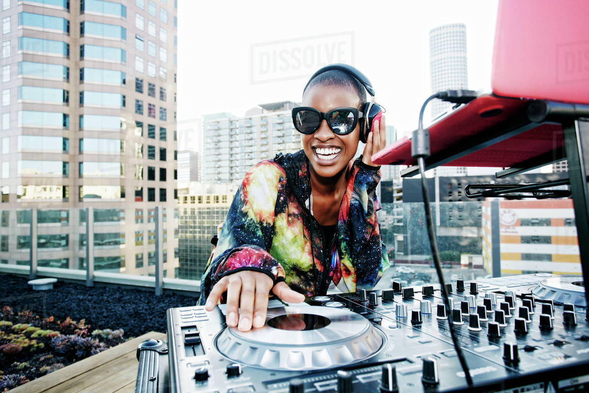 Smiling Black DJ on urban rooftop - Royalty-free Stock Photo | Dissolve