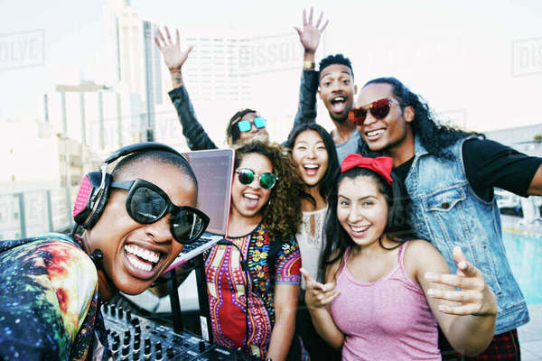 Friends smiling with DJ on urban rooftop - Royalty-free Stock Photo ...